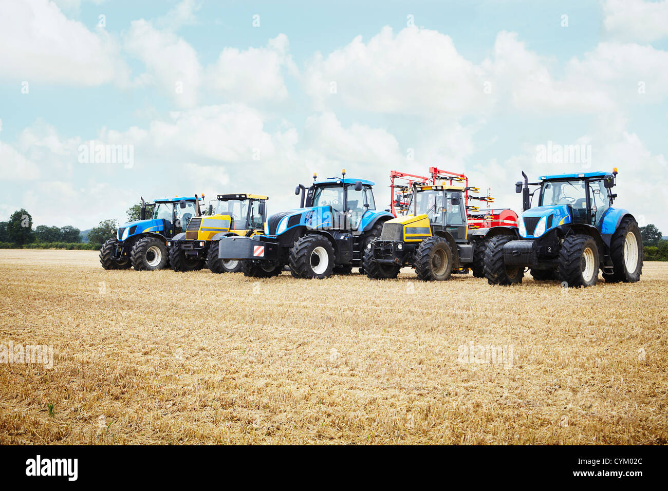 Tractors parked in tilled crop field Stock Photo - Alamy
