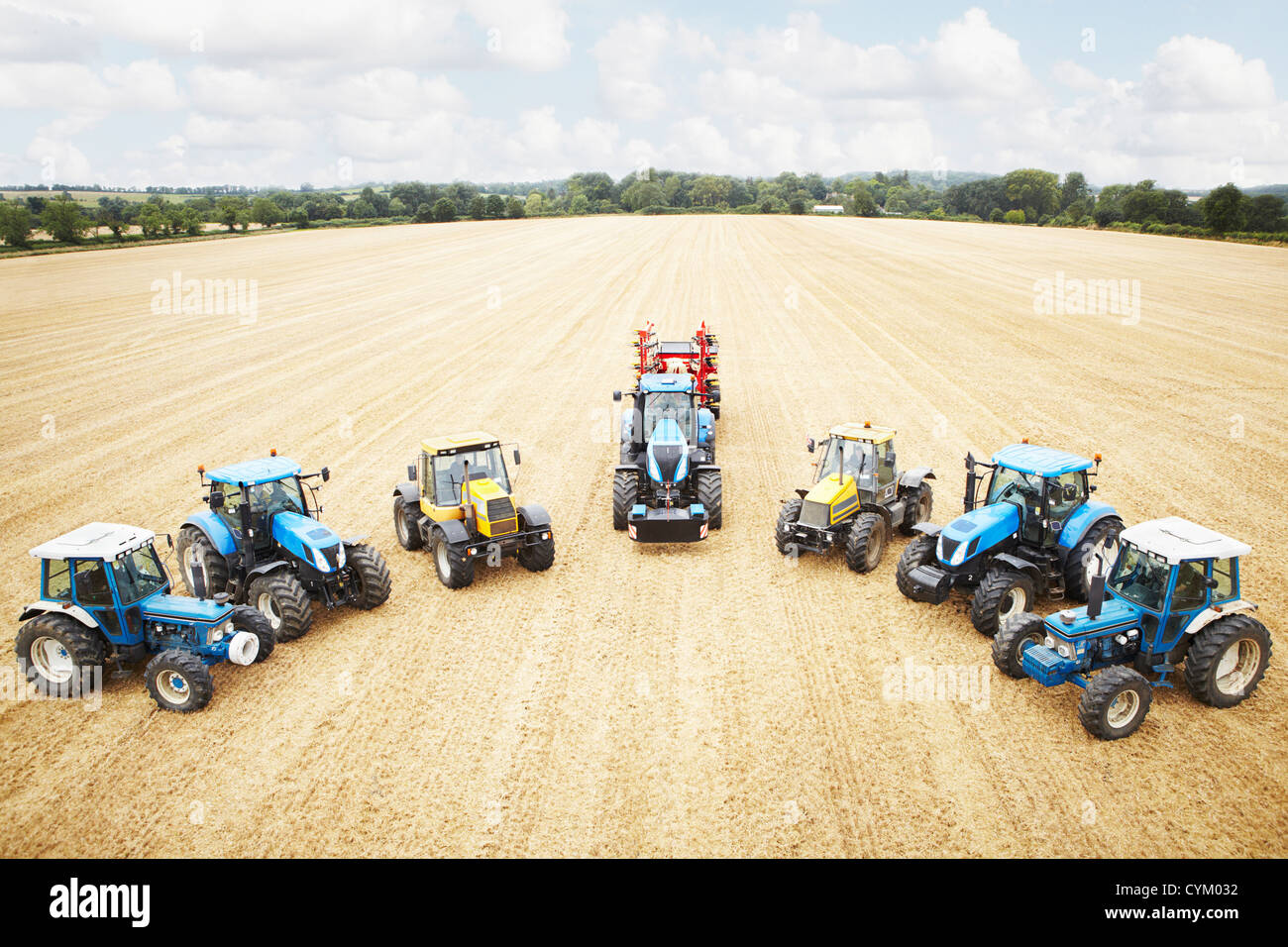 Tractors parked in tilled crop field Stock Photo - Alamy