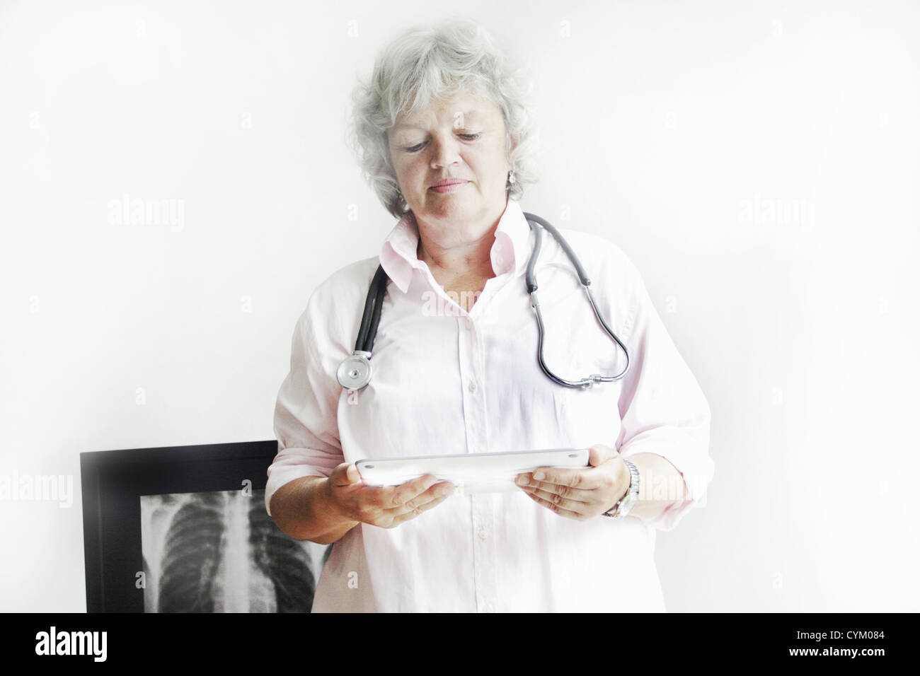 Medic reading on tablet pc hi-res stock photography and images - Alamy