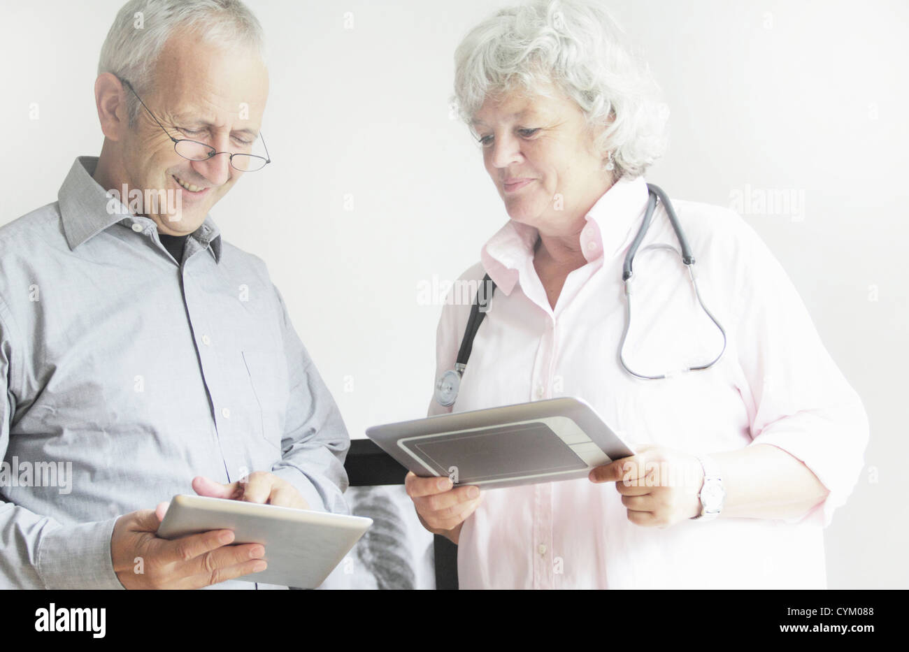 Doctors using tablet computers Stock Photo - Alamy