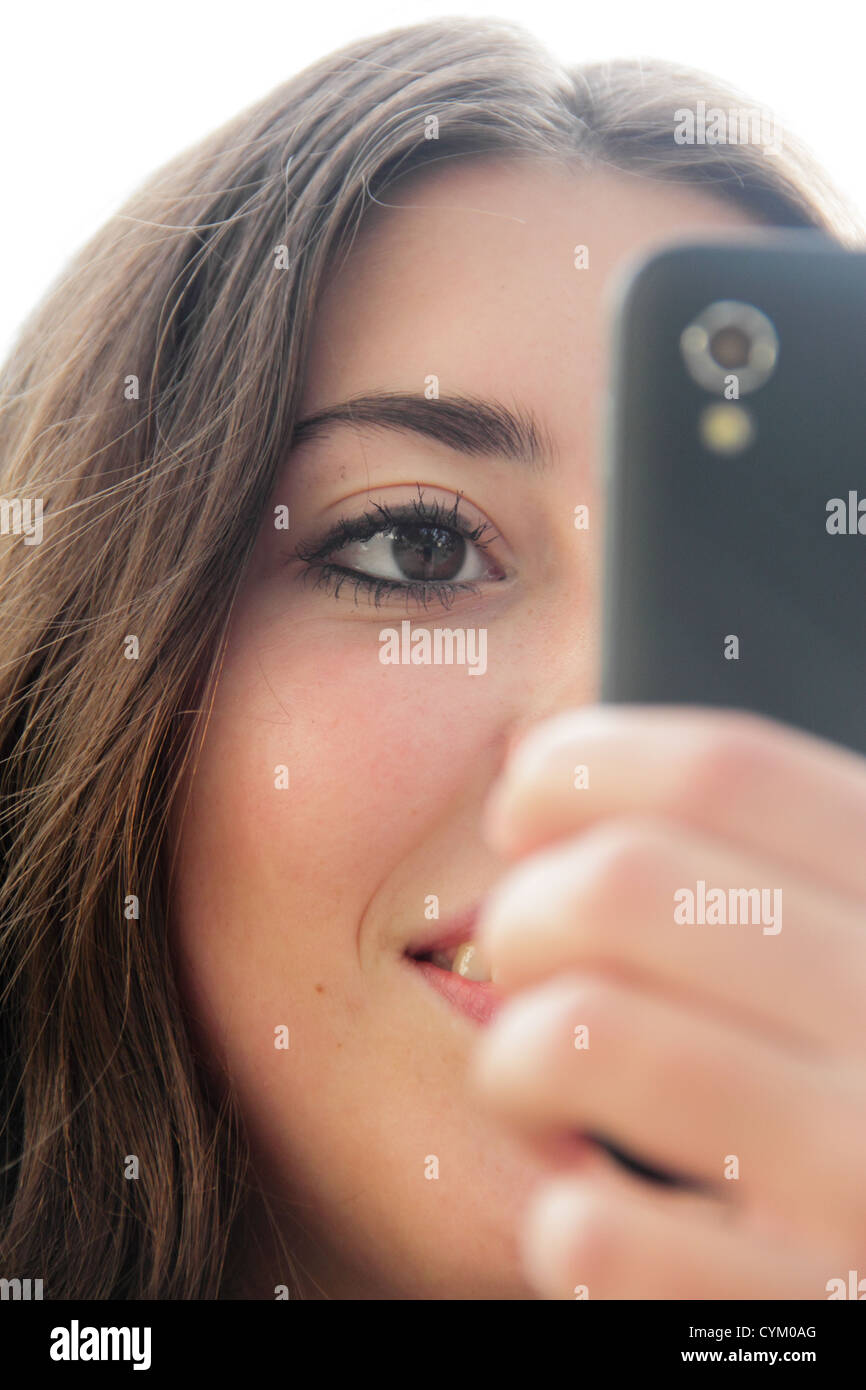 Teenage girl using cell phone outdoors Stock Photo - Alamy