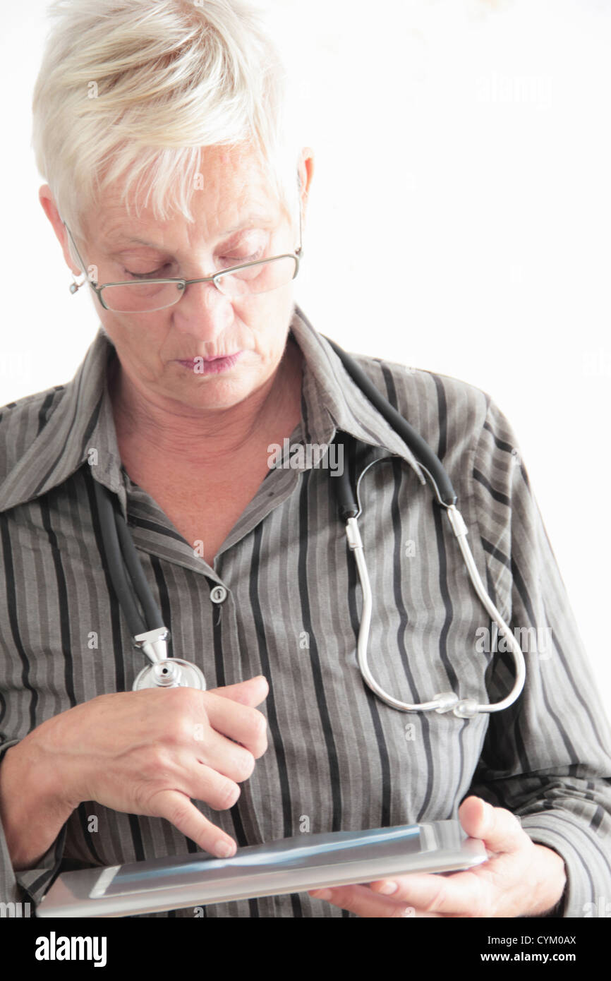 Medic reading on tablet pc hi-res stock photography and images - Alamy