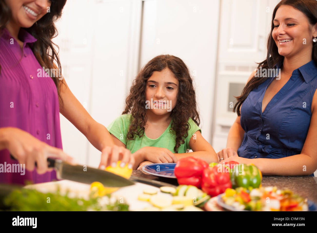 Sisters cooking together in kitchen Stock Photo - Alamy