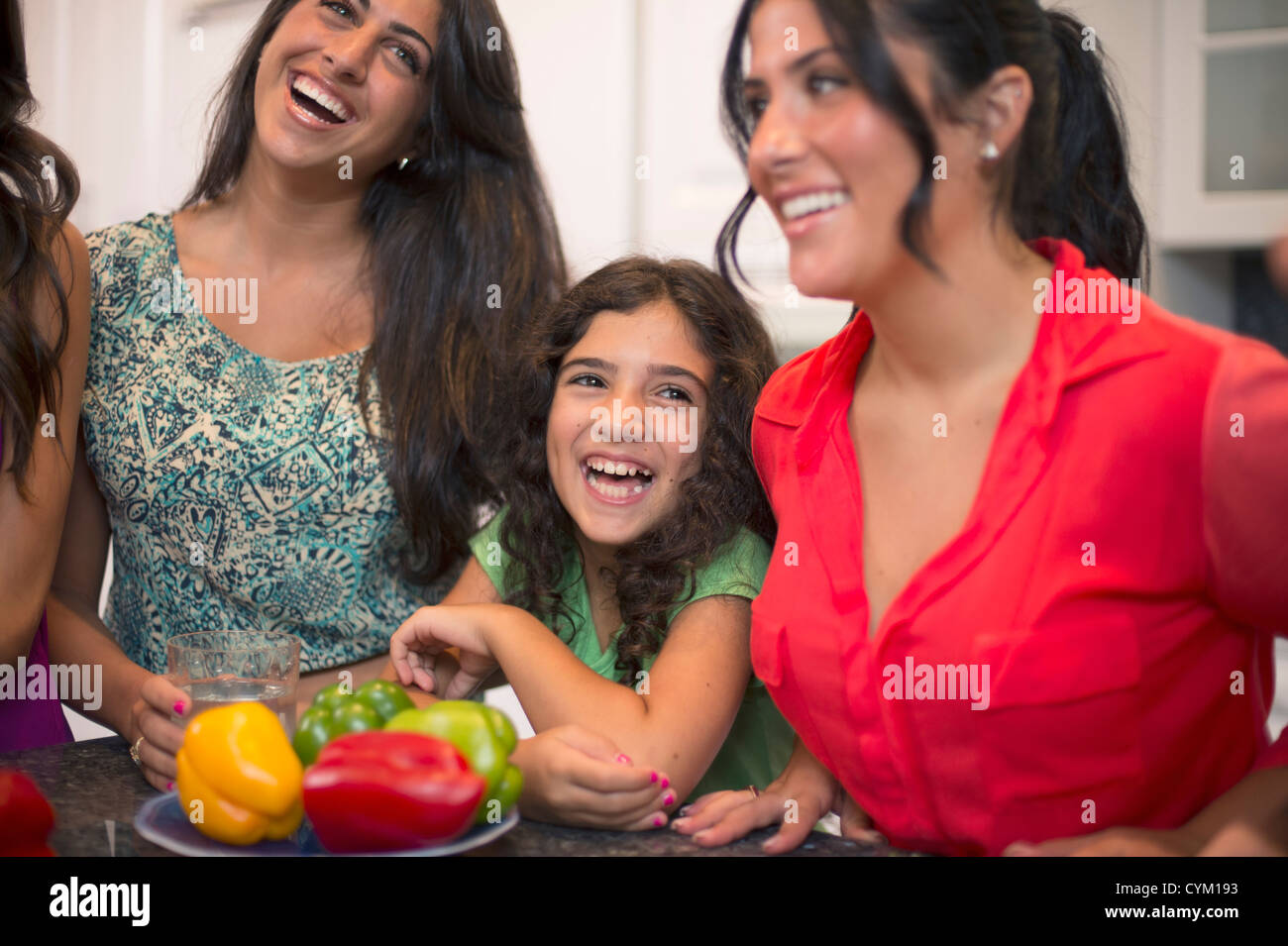 Sisters laughing together in kitchen Stock Photo - Alamy