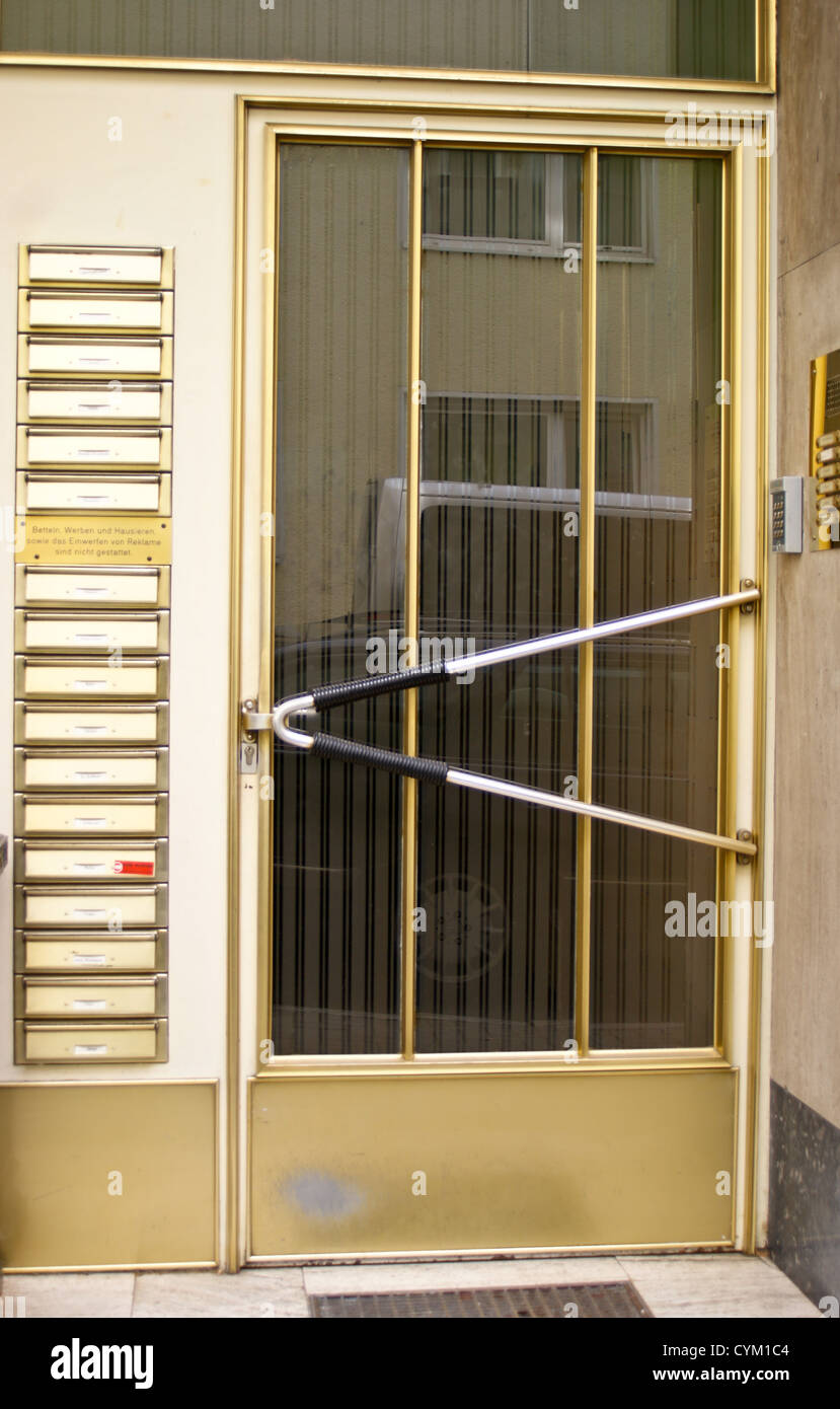 A modern gold anodised aluminium apartment block entrance doorway ...