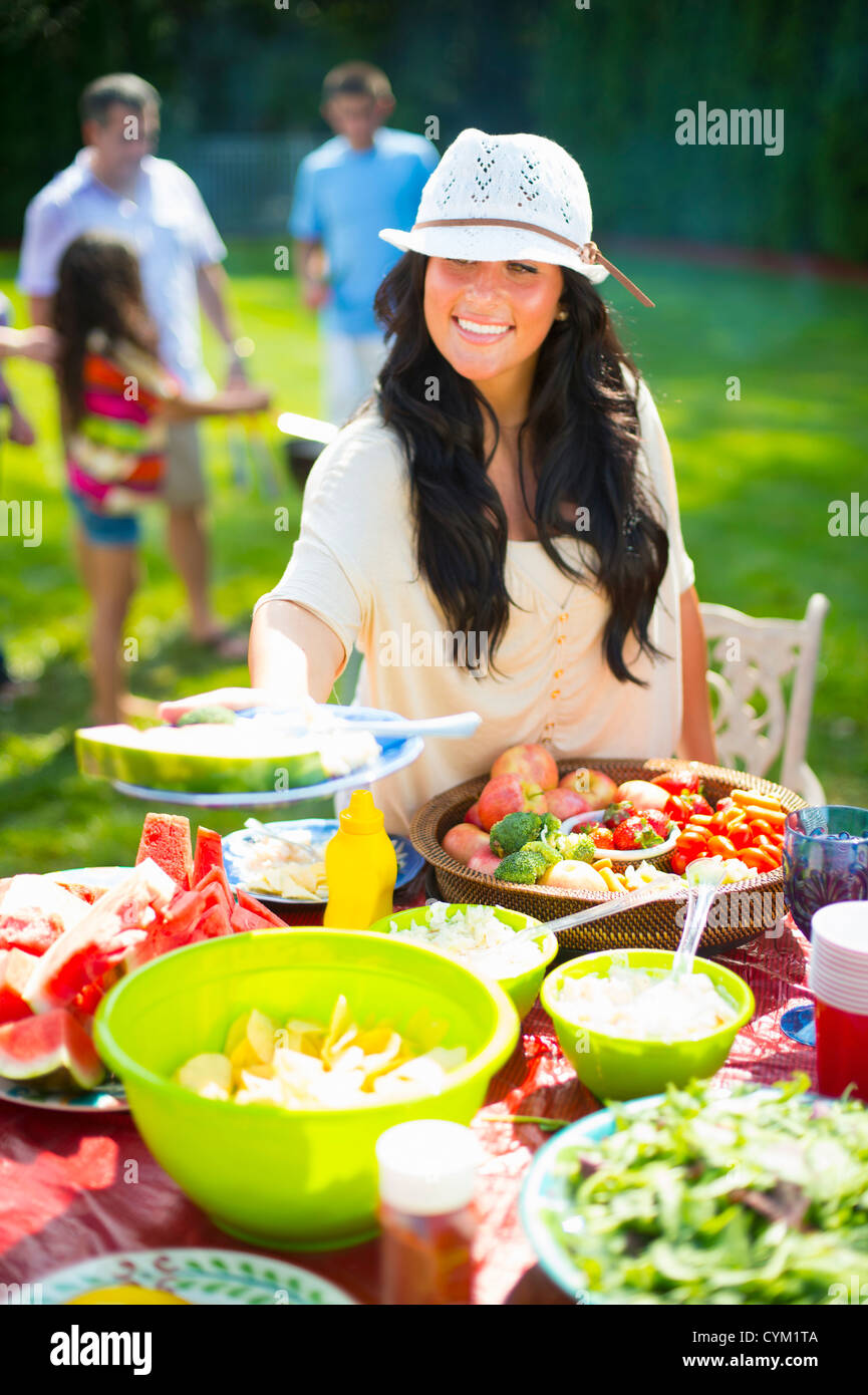 Woman serving food outdoors Stock Photo - Alamy