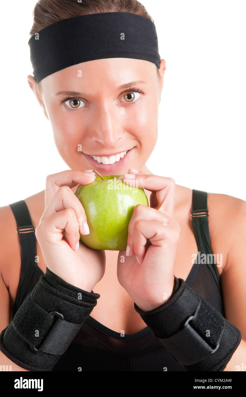 Woman about to eat a green apple after her workout at the gym Stock ...