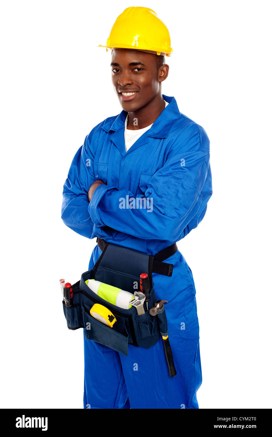 Smiling african worker posing with arms crossed isolated on white ...