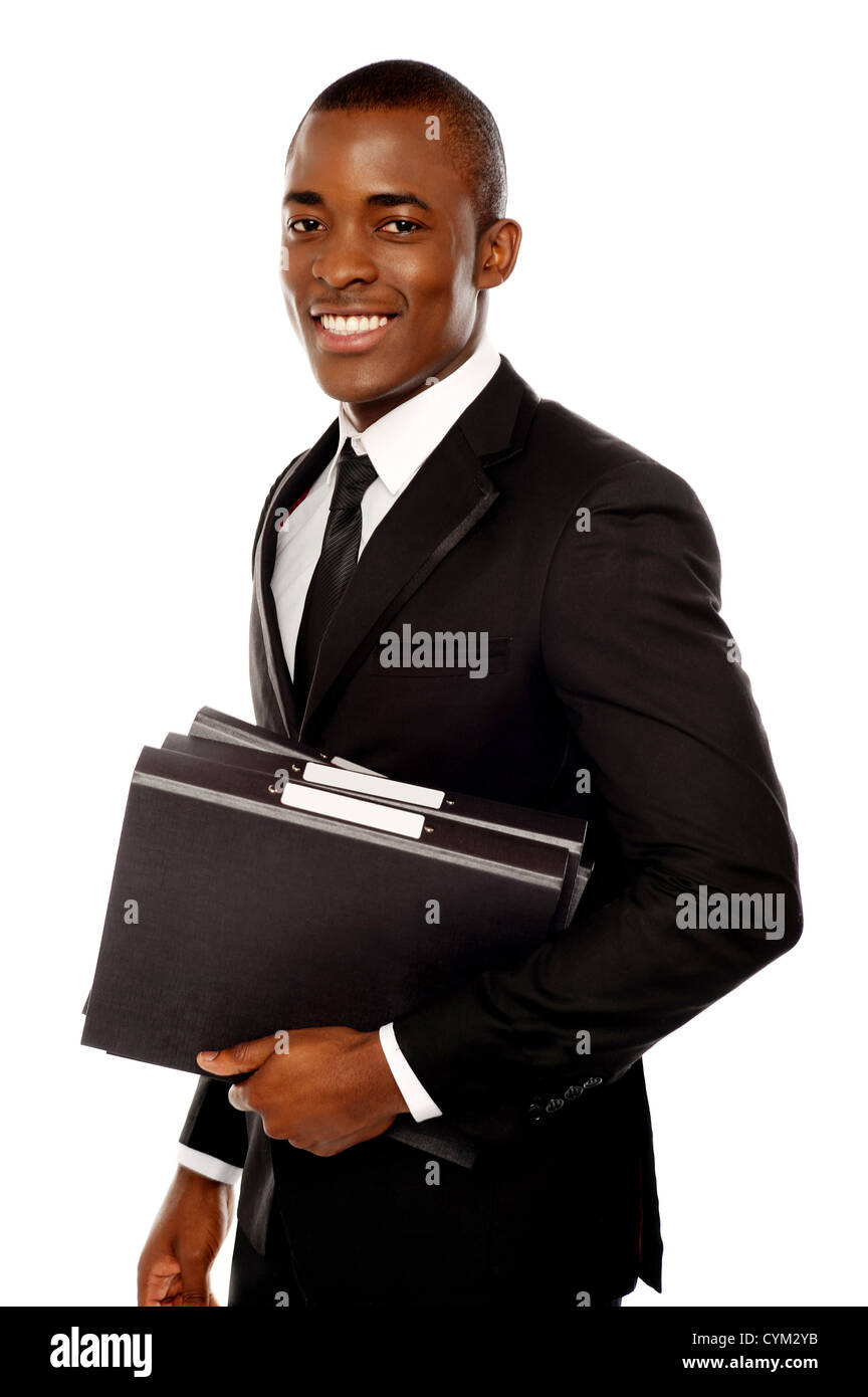 Handsome young executive holding files looking at camera Stock Photo ...