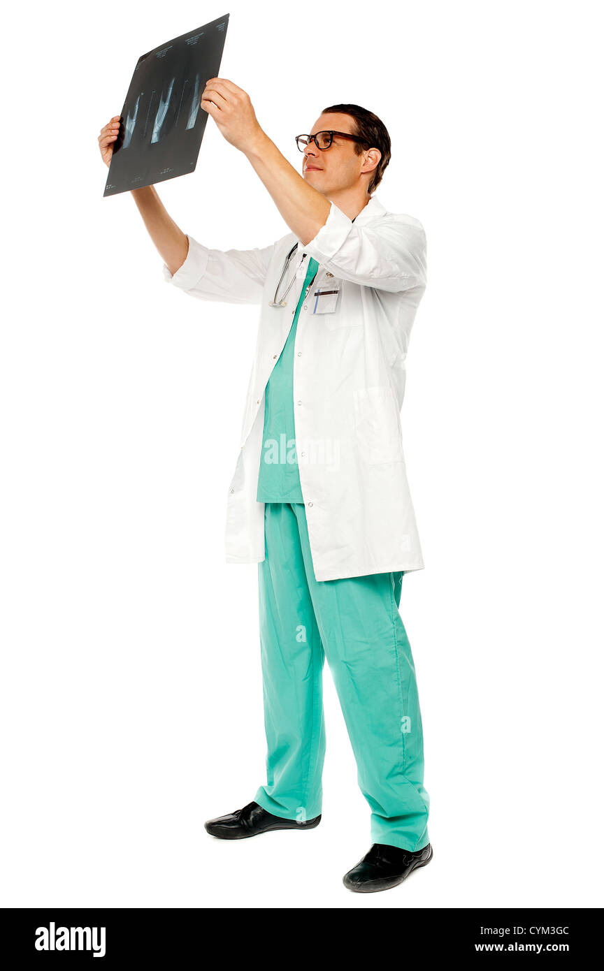 Experienced surgeon looking at patient's x-ray,full length portrait ...