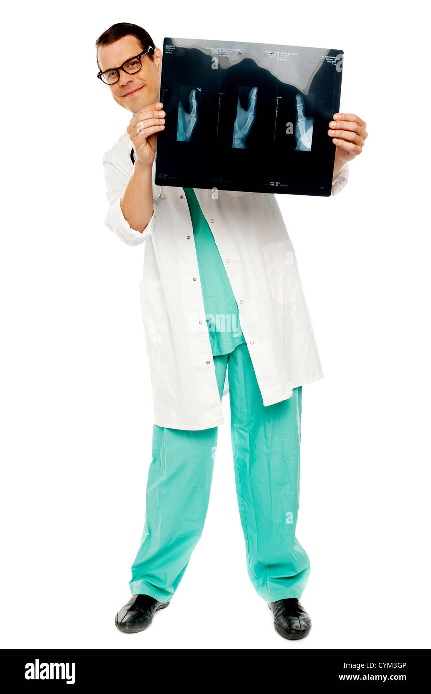 Young surgeon showing x-ray report of patient, full length portrait ...