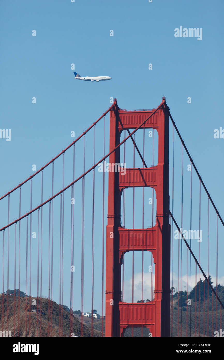 747 jumbo jet flies low over the Golden Gate Bridge and San Francisco ...