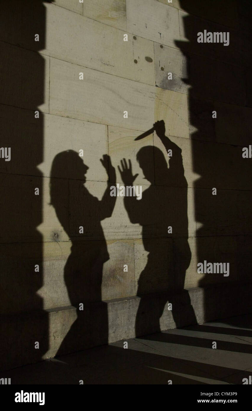 Man attacks woman with a knife in a dark alley. Pic posed by models ...