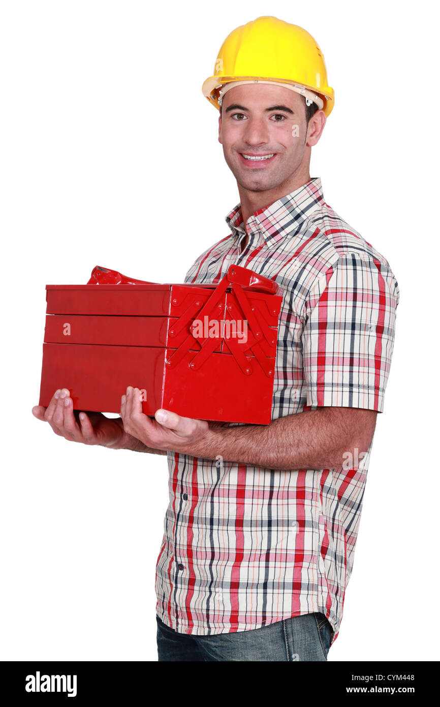 Workman carrying toolbox Stock Photo - Alamy