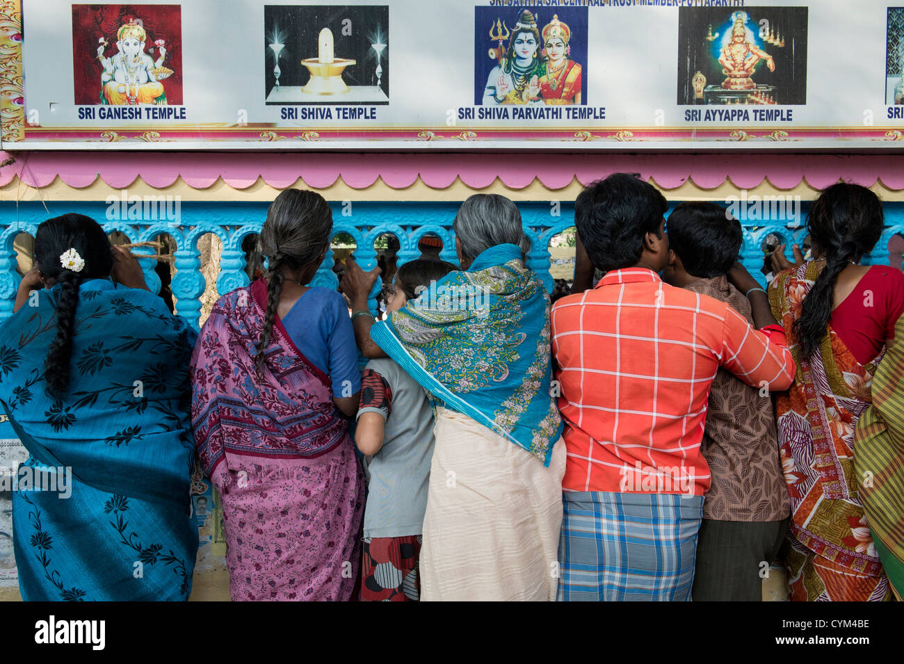 Line of Indian village people standing outside a village temple ...