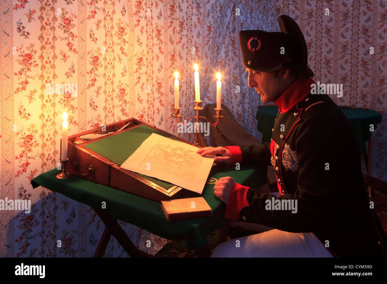 Napoleon Bonaparte sitting in his tent preparing next day's battle by ...