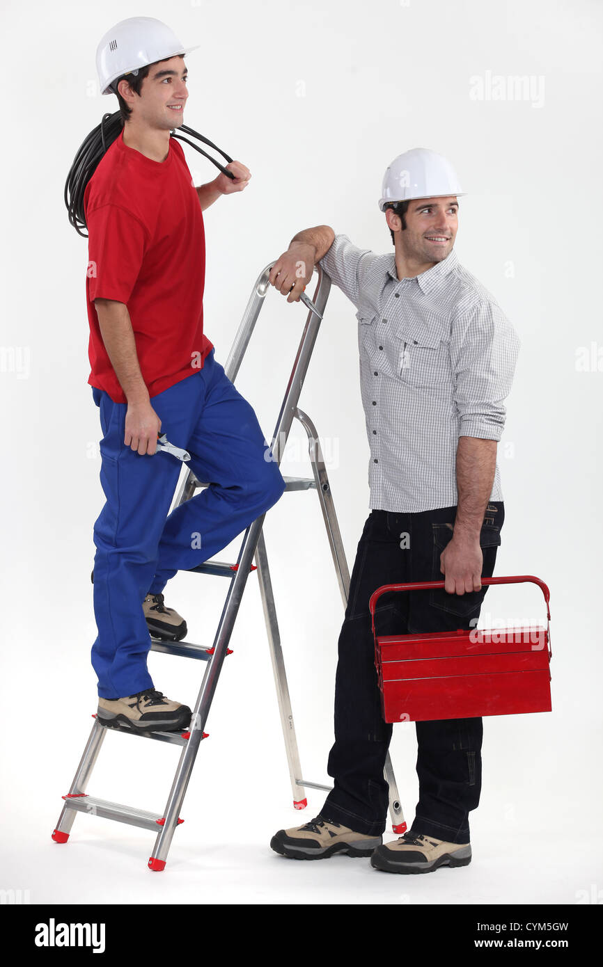 Two electricians on white background Stock Photo - Alamy