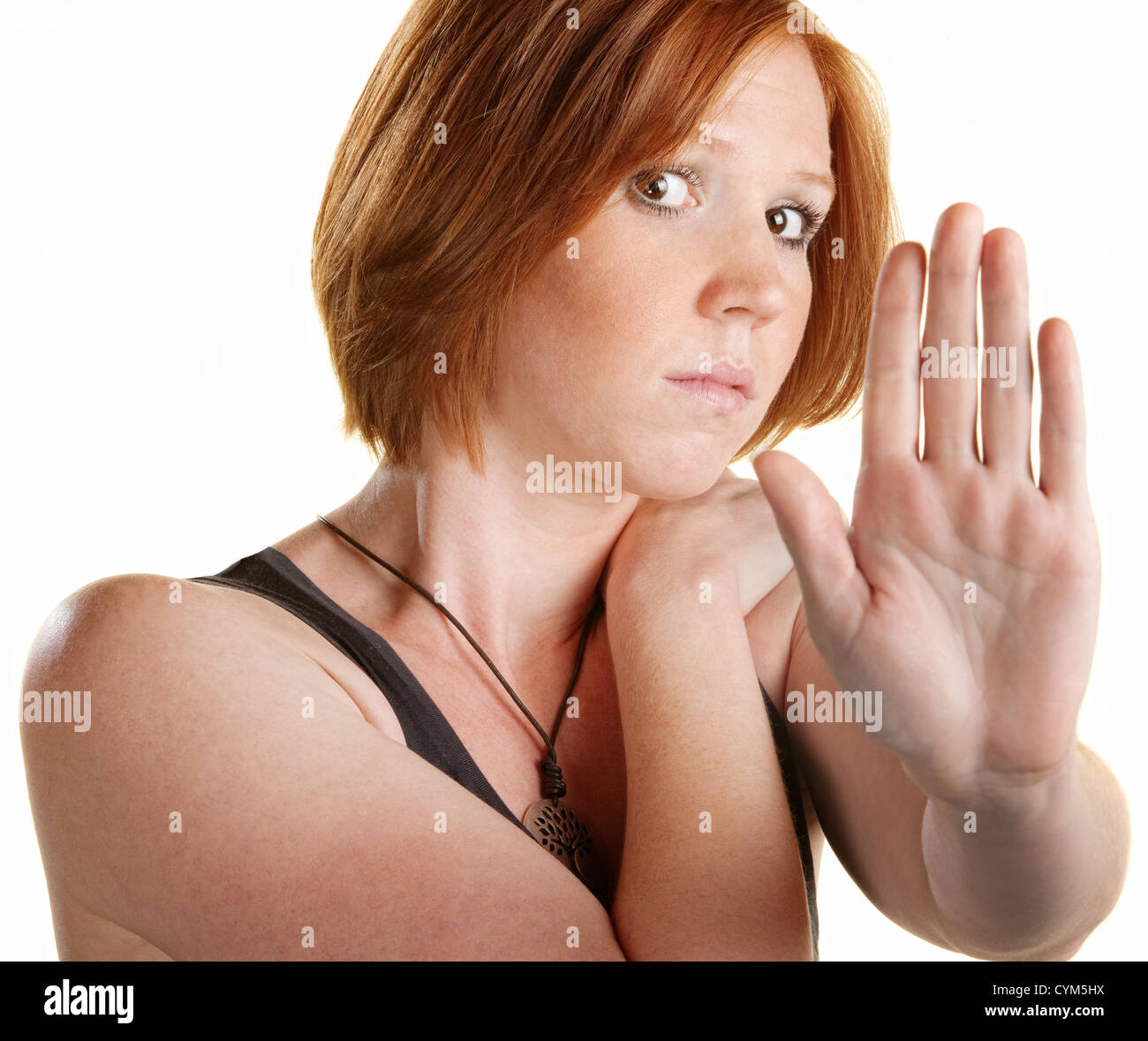 Scared woman with hand up over white background Stock Photo - Alamy