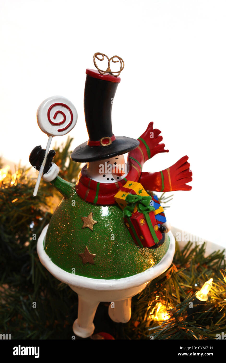 A decorative christmas snowman, white background and christmas lights ...