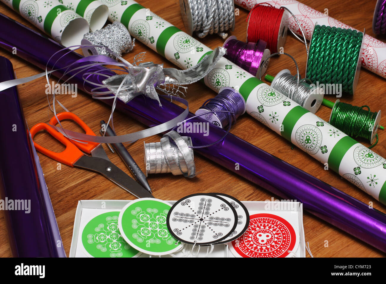 a bunch of wrapping paper, ribbons, label tags and other present ...