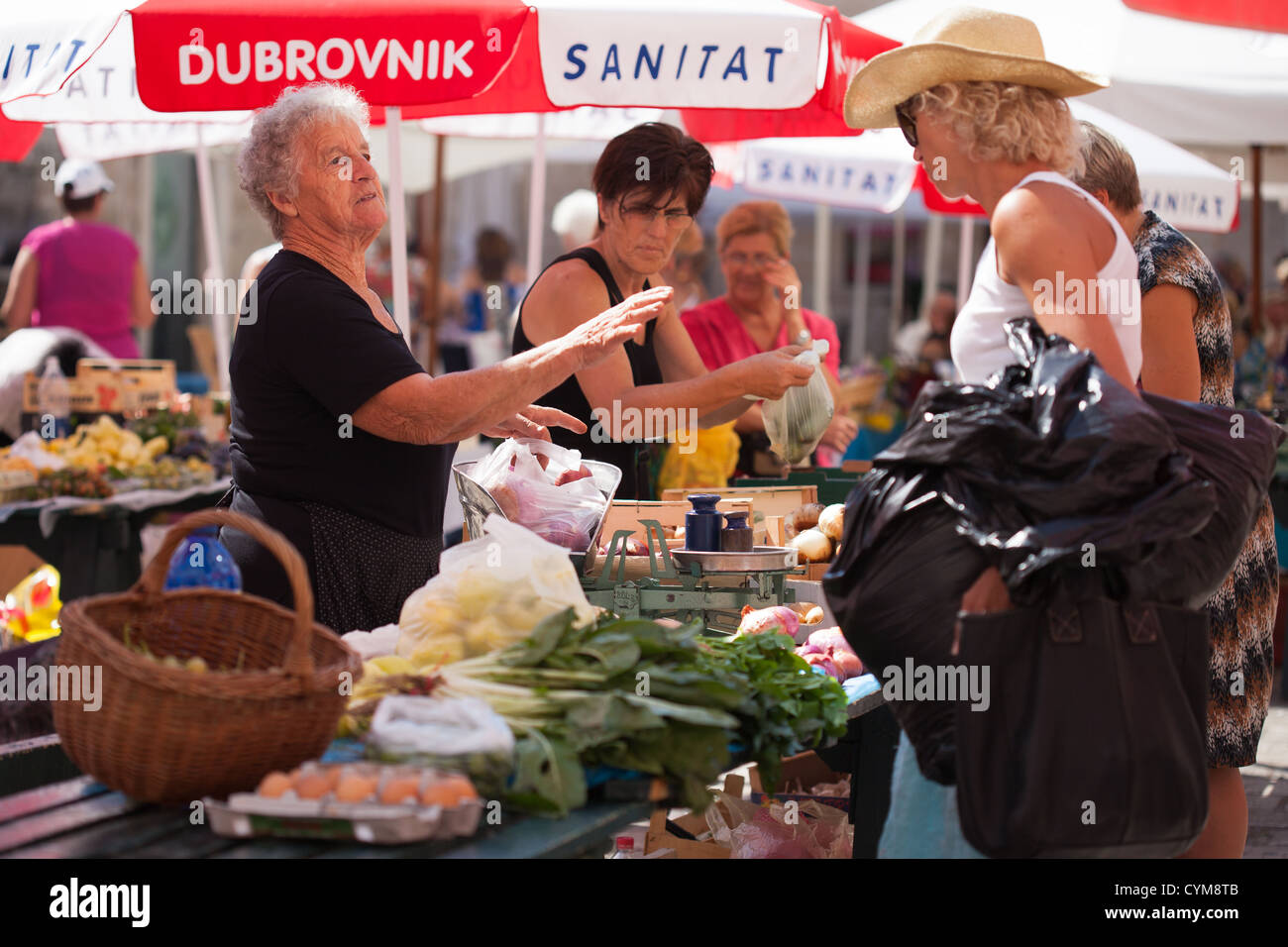 Older woman. Stall holder. Shoppers in Dubrovnik outdoor city market ...