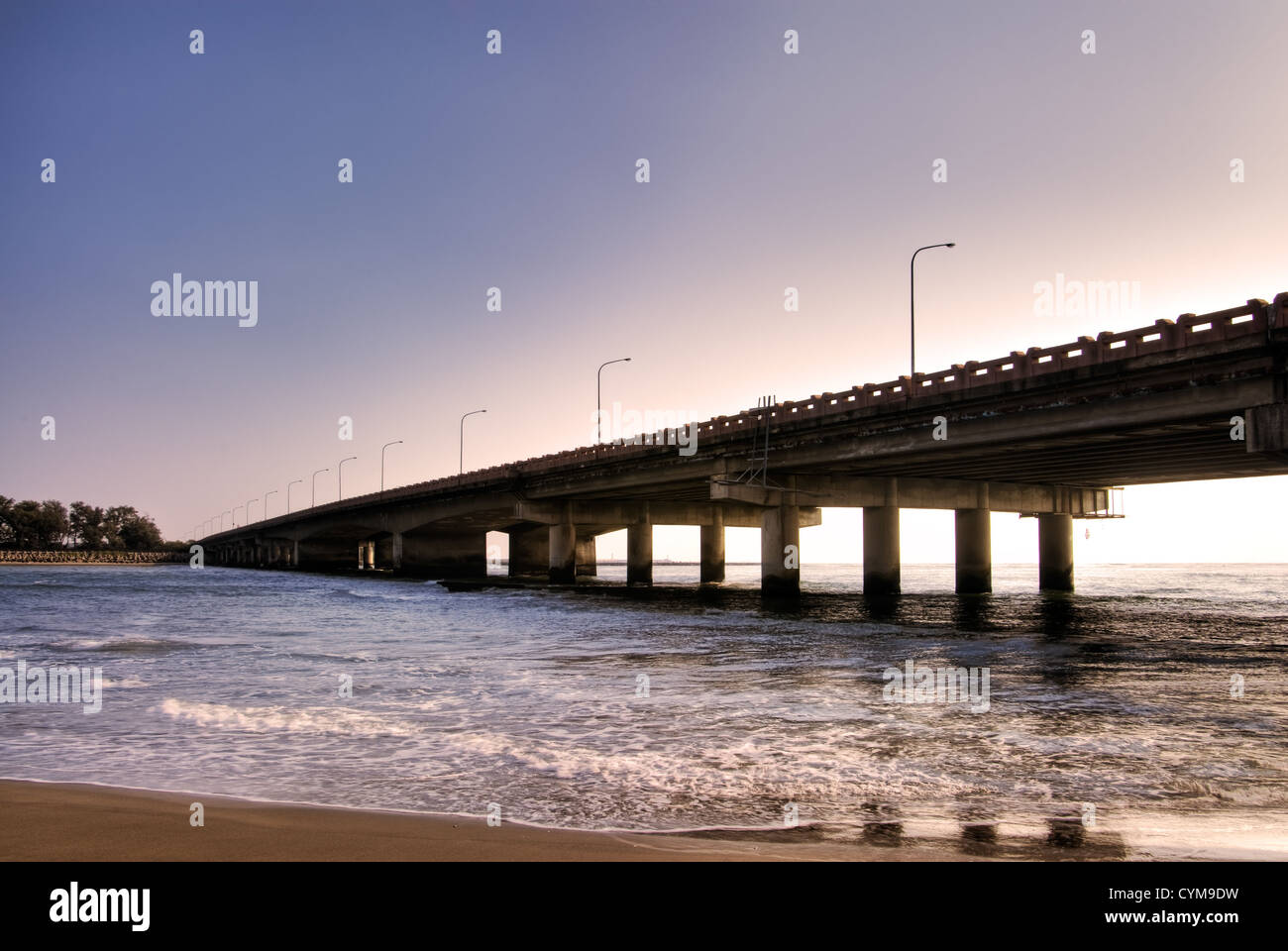 Landscape of sunset with bridge over ocean Stock Photo - Alamy