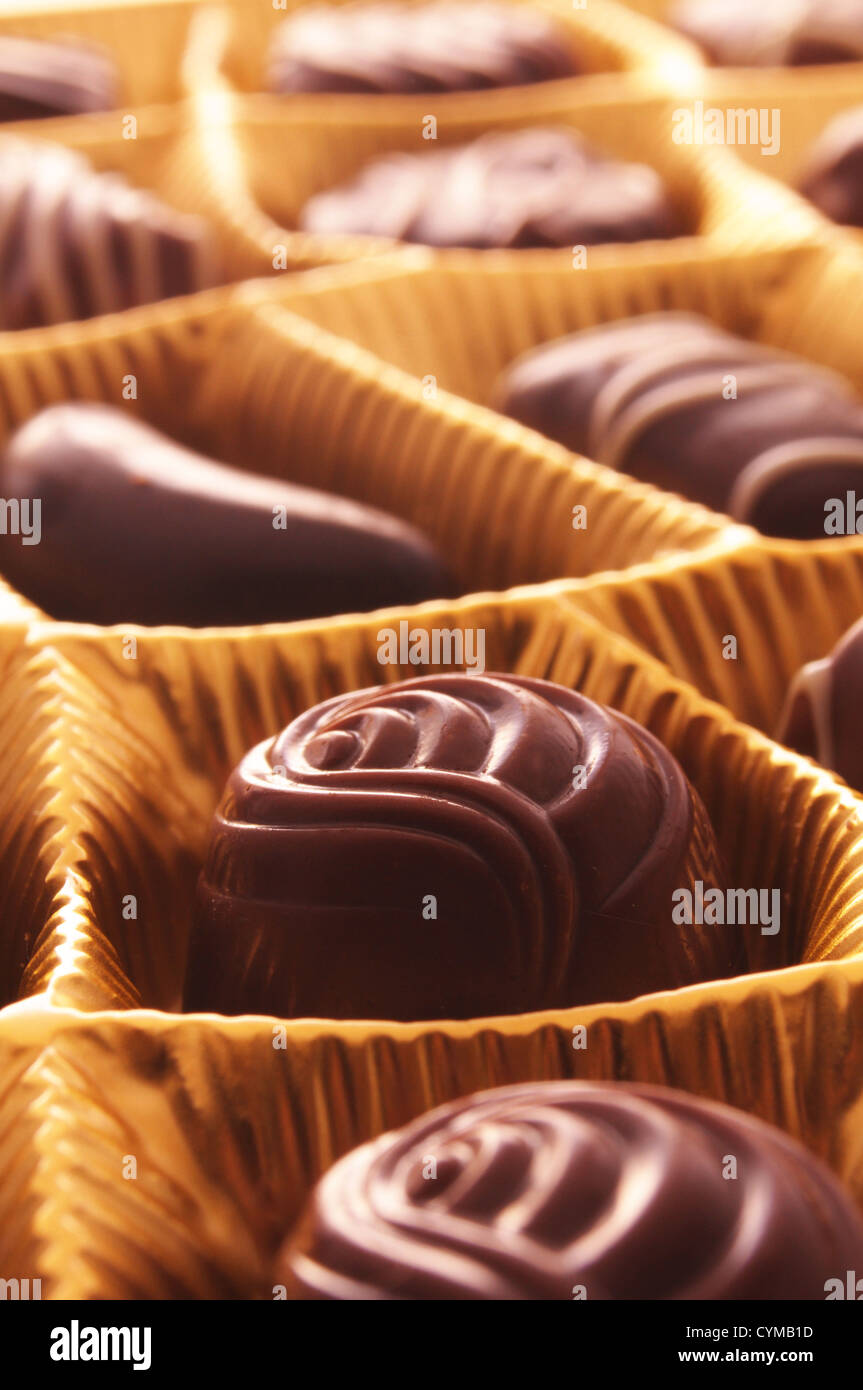 chocolate praline in golden present box for valentines day Stock Photo ...