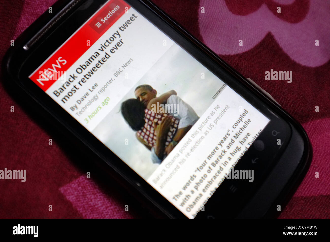 A smartphone screen showing news of Barack Obama's victory tweet ...