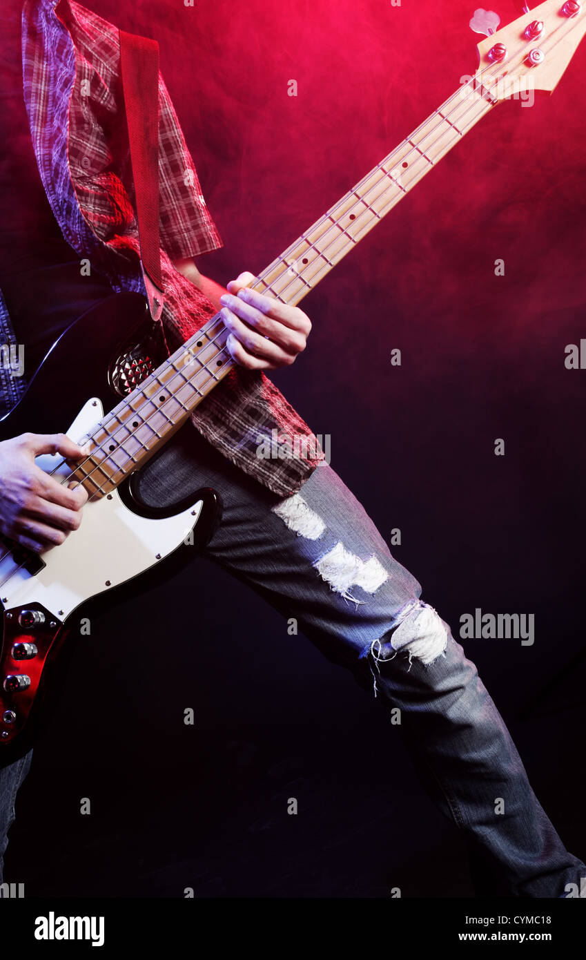 a bassist plays at a live concert Stock Photo - Alamy