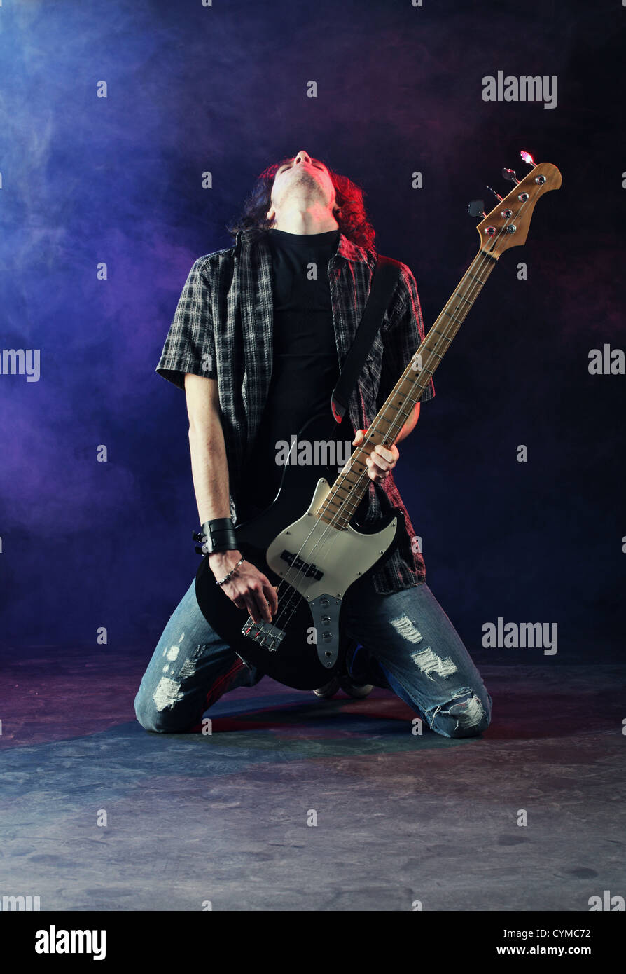 a bassist plays at a live concert Stock Photo - Alamy