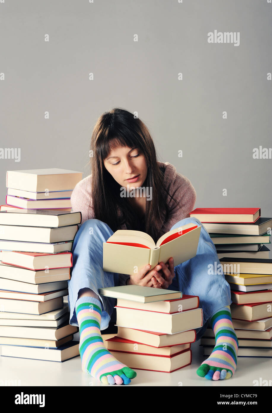 Cute girl studying big stack hi-res stock photography and images - Alamy