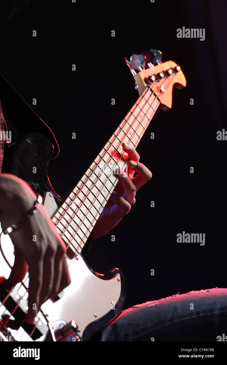 a bassist plays at a live concert Stock Photo - Alamy