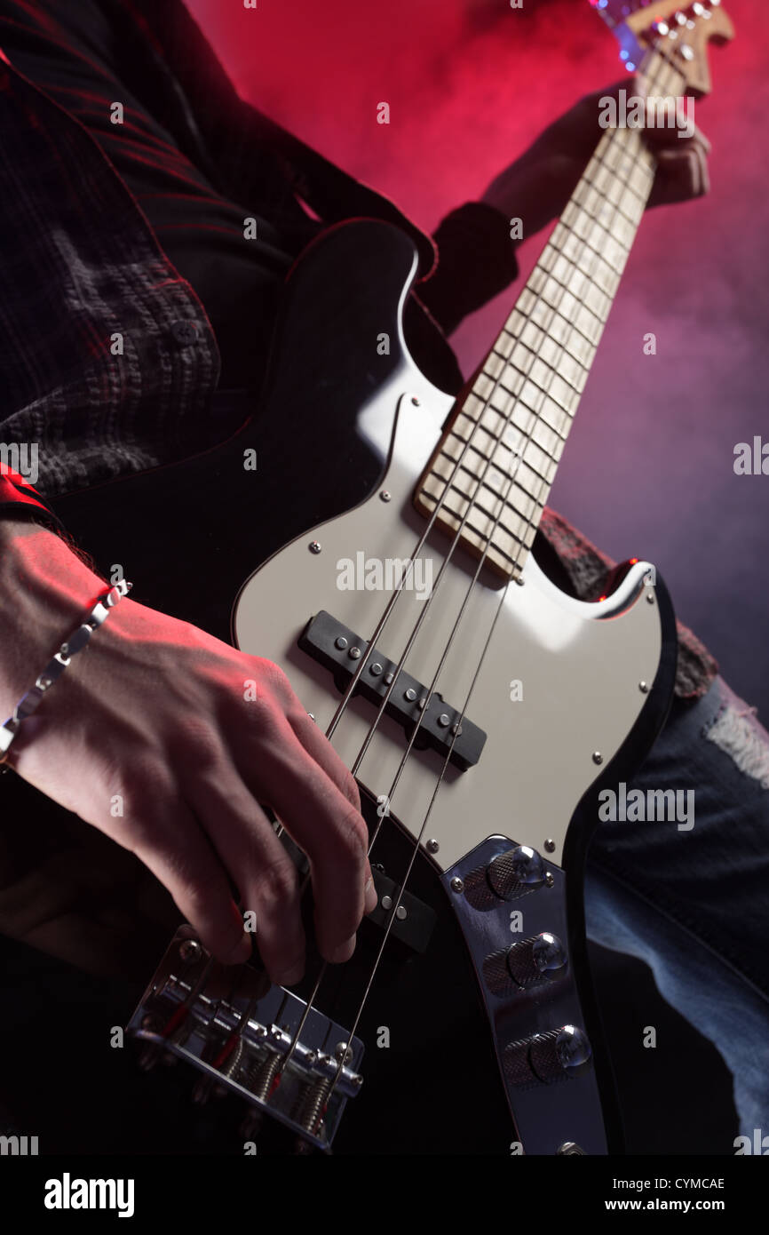 a bassist plays at a live concert Stock Photo - Alamy