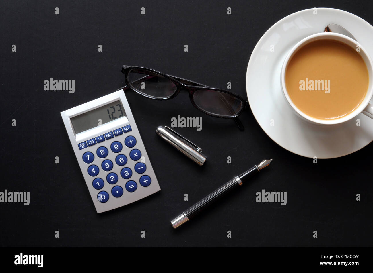 business breakfast in the office on black desktop with calculator pen ...