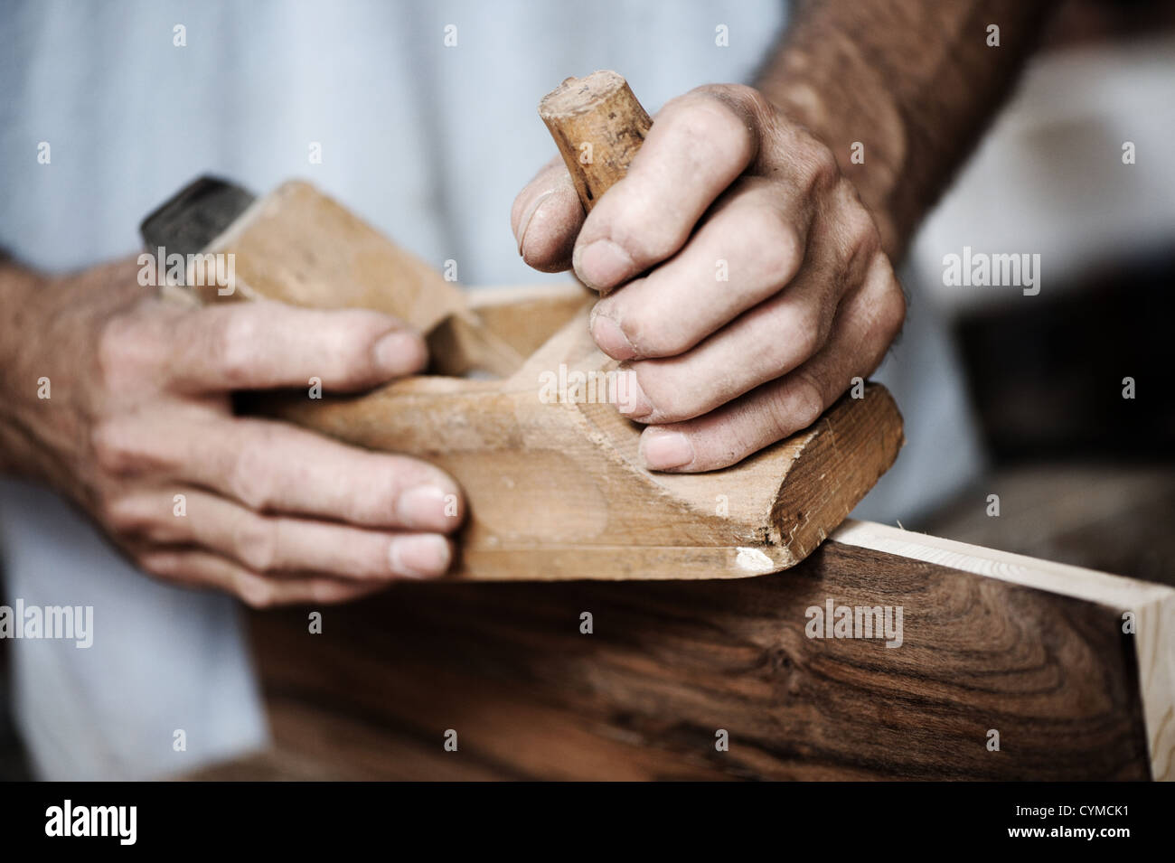 hands of a carpenter planing a plank of wood with a hand plane Stock ...