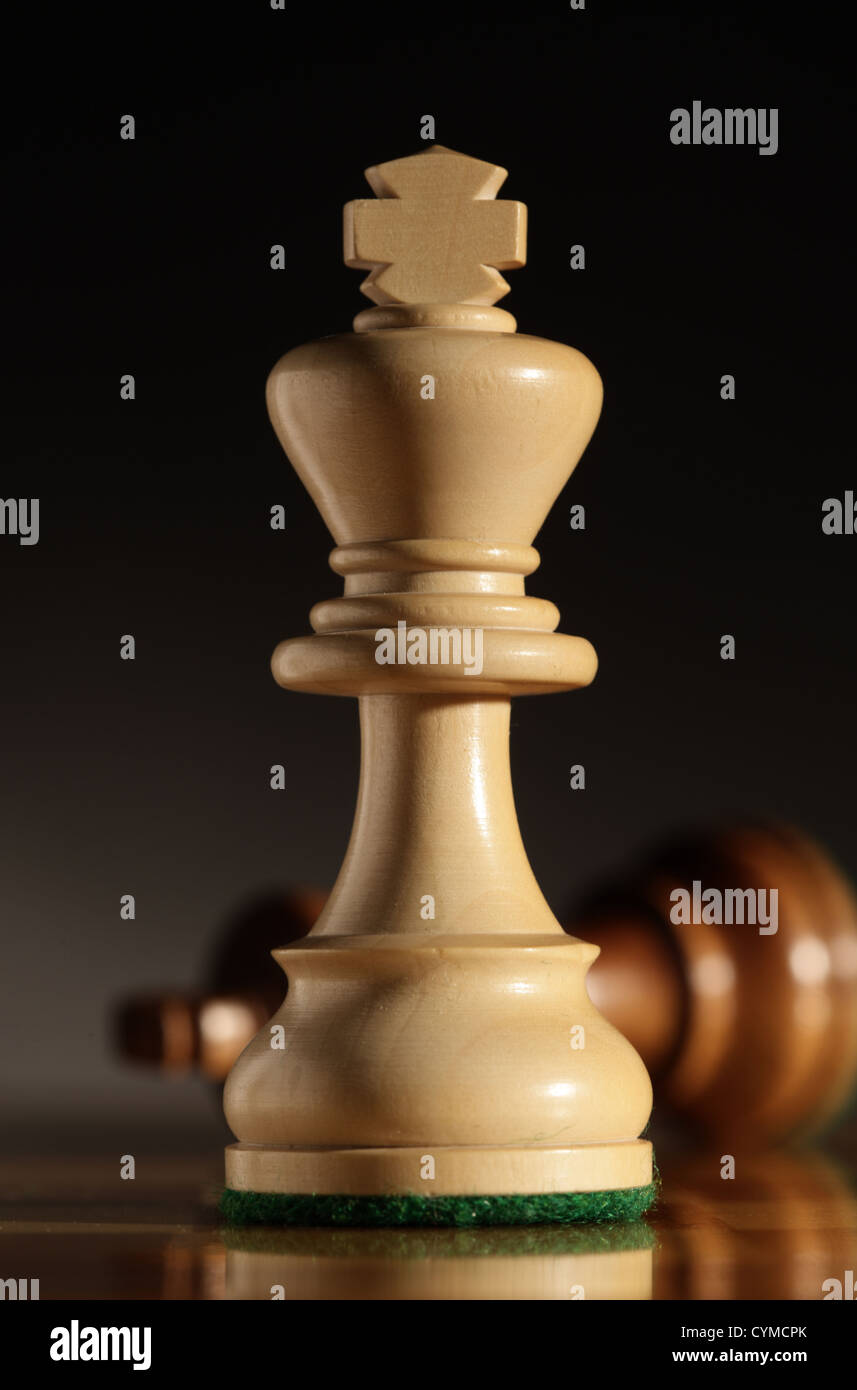 the winner: king chess piece with others in background Stock Photo - Alamy