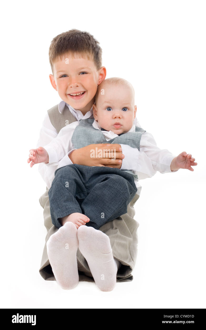 Elder kid holding his young baby brother Stock Photo - Alamy