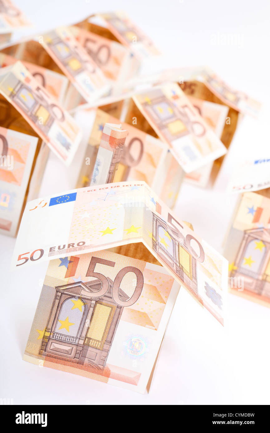 houses from Euro banknotes on white background Stock Photo - Alamy