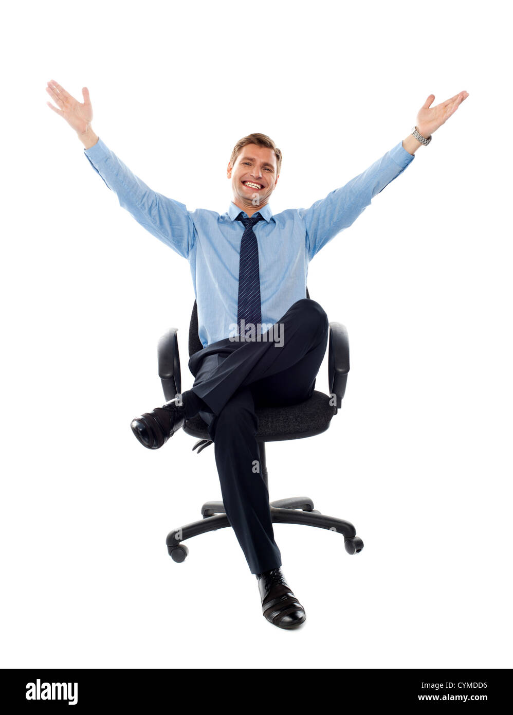 Successful businessman seated on chair with his arms raised over white ...