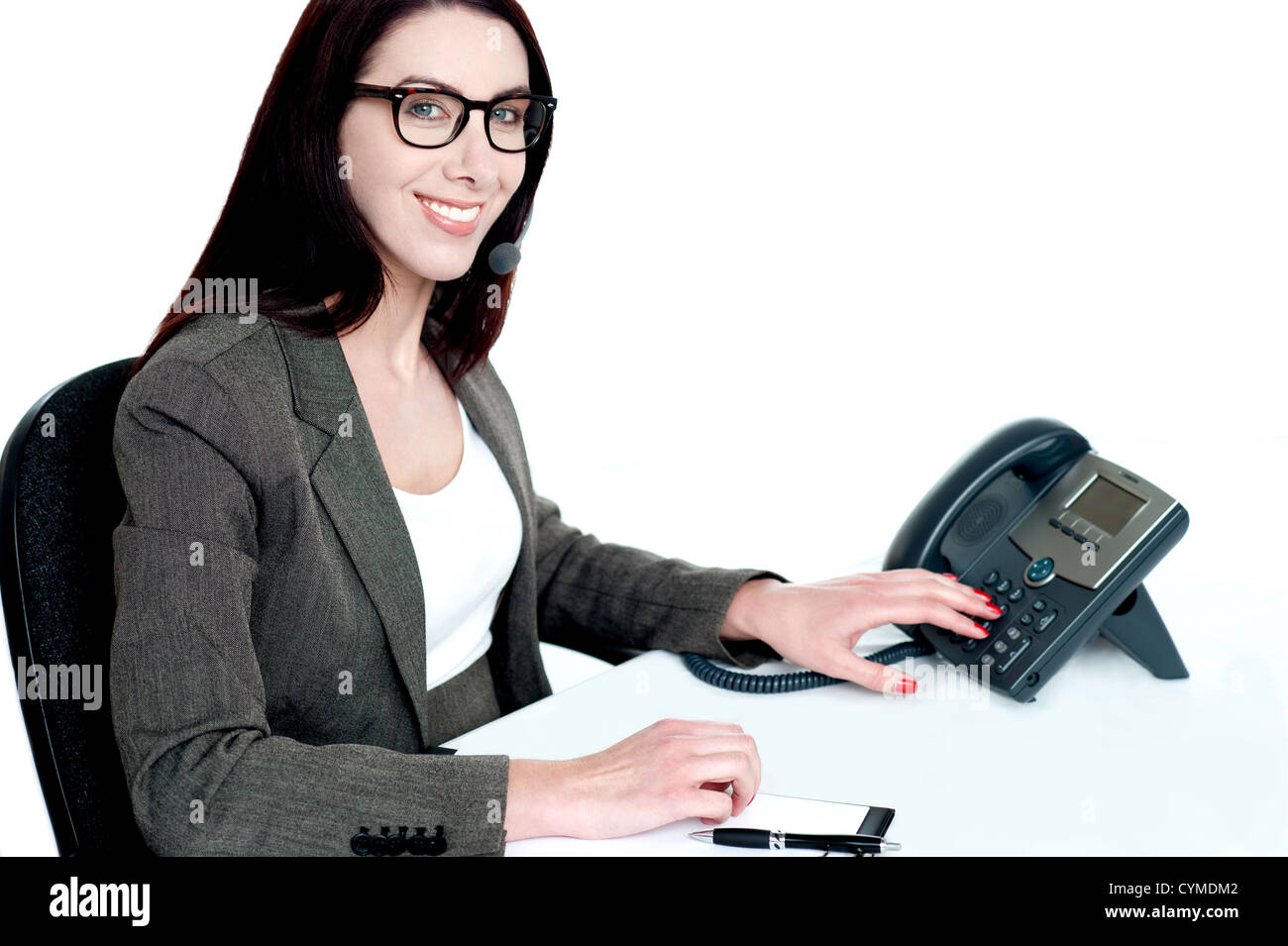 Attractive female executive dialing clients number. Actively working in ...
