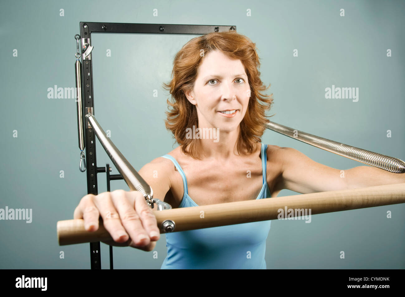 Woman using gym equipment to do a strength workout Stock Photo - Alamy