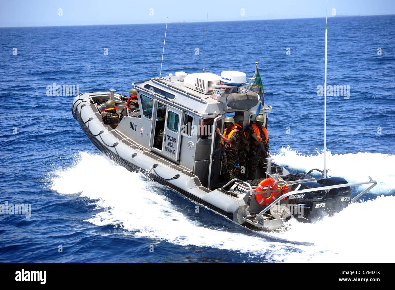 Tanzania People's Defense Force sailors pilot their boat to their ...