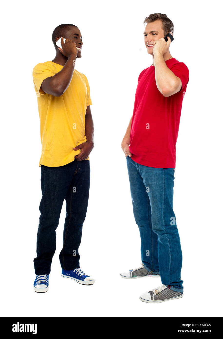 Trendy handsome guys attending call on cellphone. Full length portrait ...