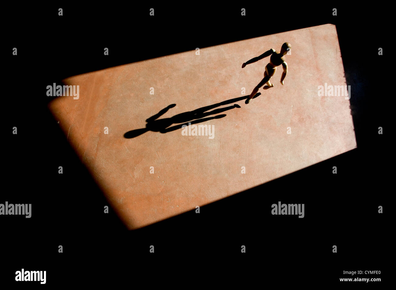 Artist's model with heavy backlight walks and throws a long shadow ...