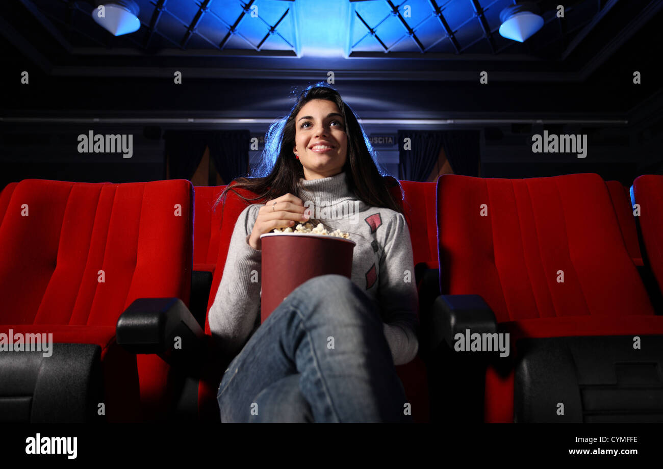 watching a movie at the cinema: portrait of a pretty girl in a movie ...