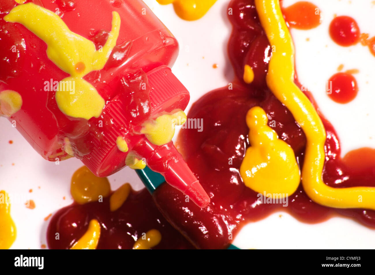 Ketchup squeeze bottle and messy condiments on a plate Stock Photo - Alamy