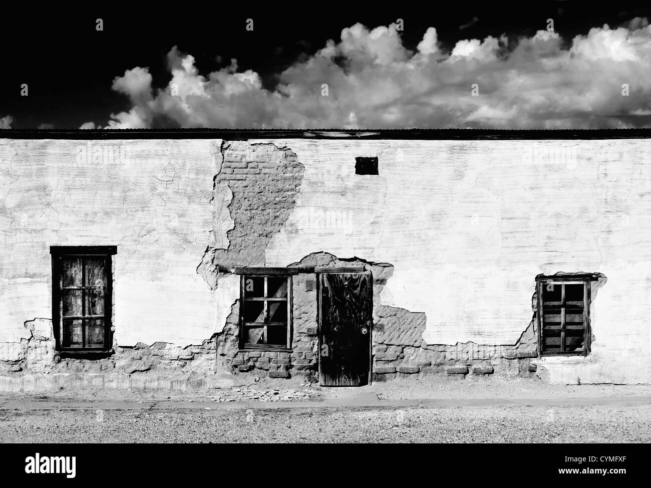 Boarded and abandoned adobe building with a door and windows Stock ...