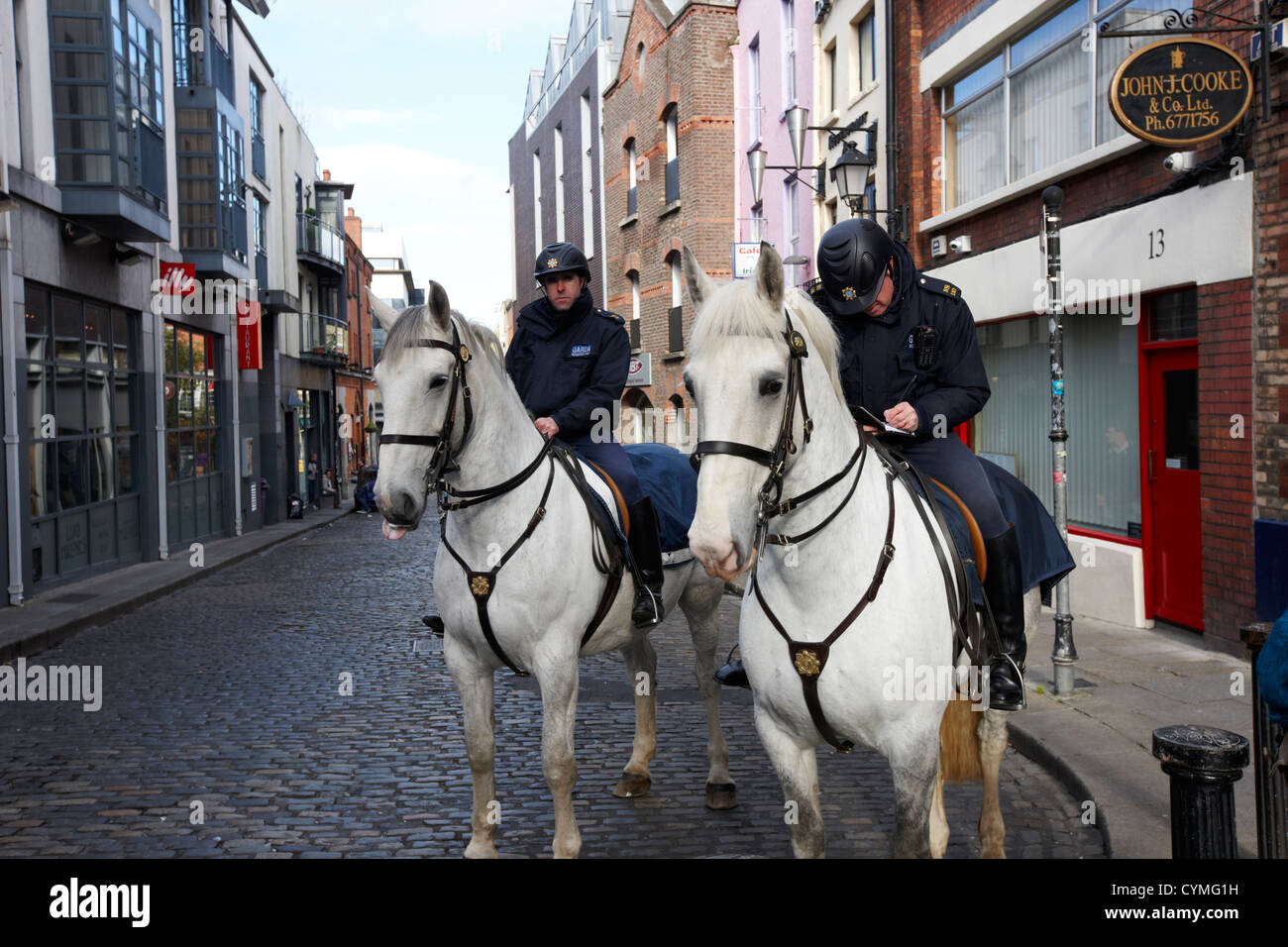 garda siochana mounted police on horseback taking notes in temple bar ... garda siochana mounted police on horseback taking notes in temple bar ...