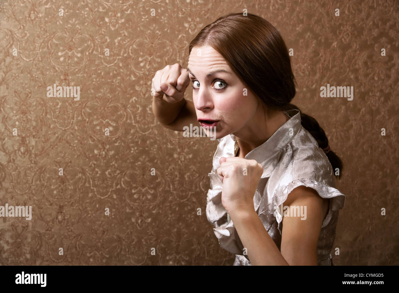 Pretty Young Angry Woman Throwing a Punch Stock Photo - Alamy