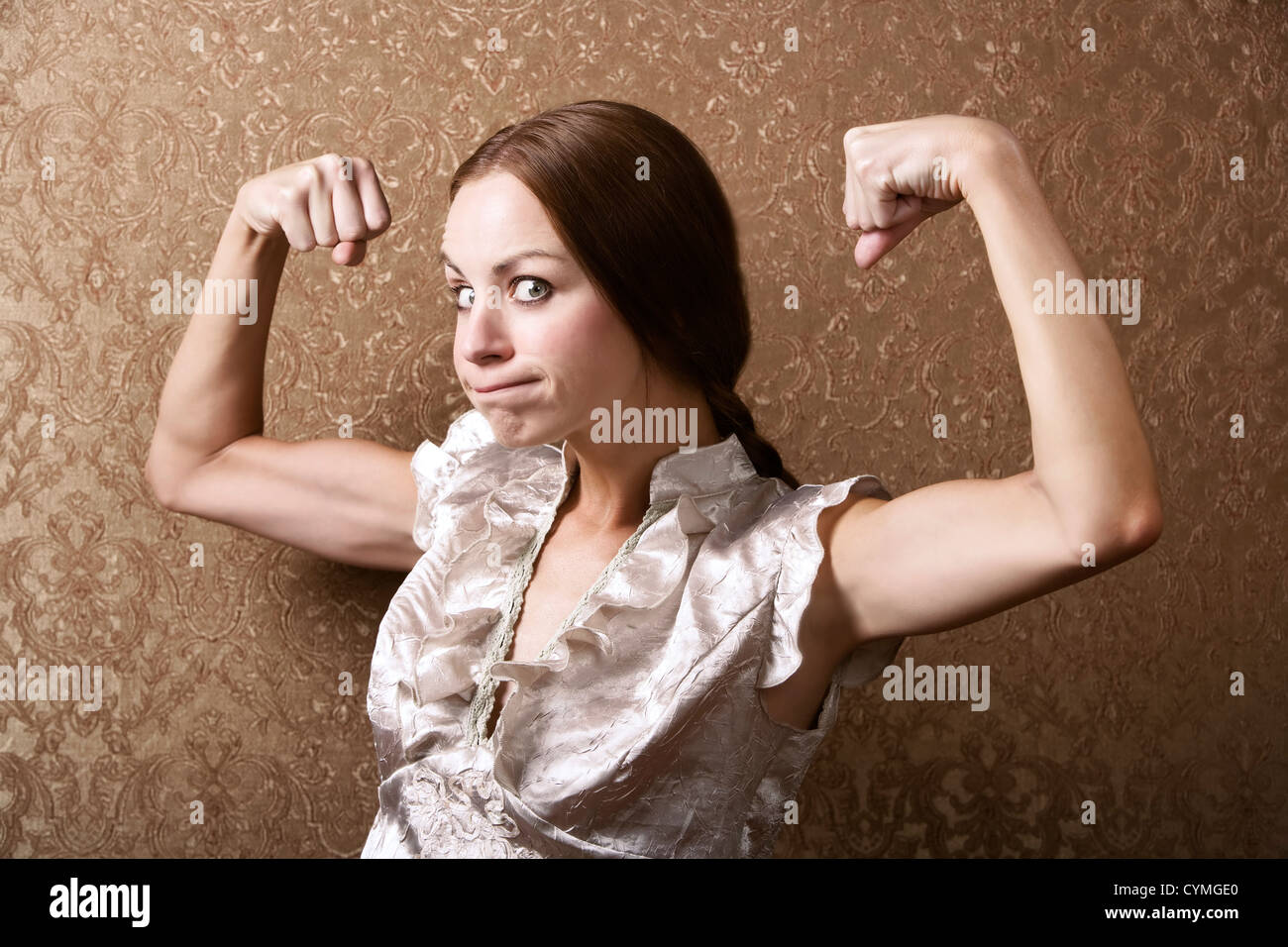 Portrait of a Pretty Young Woman Flexing Her Biceps Stock Photo - Alamy